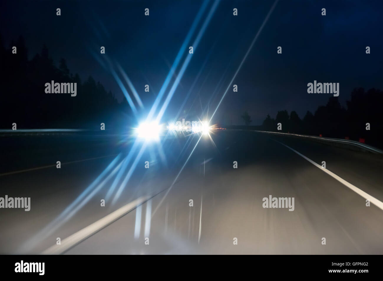 Cars driving in dark oncoming hi-res stock photography and images - Alamy