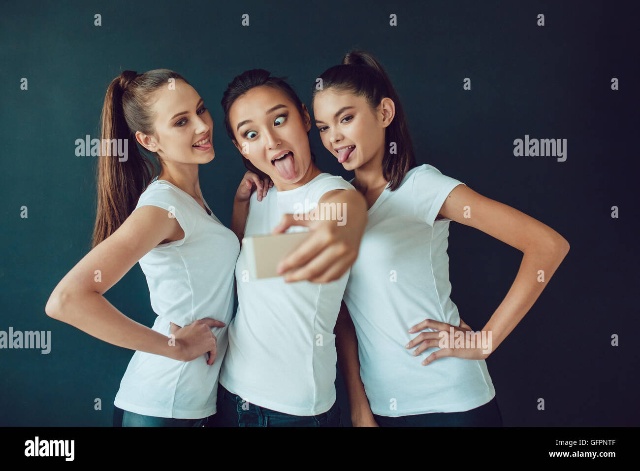 Positive friends portrait of happy girls making selfie, sure funny ...