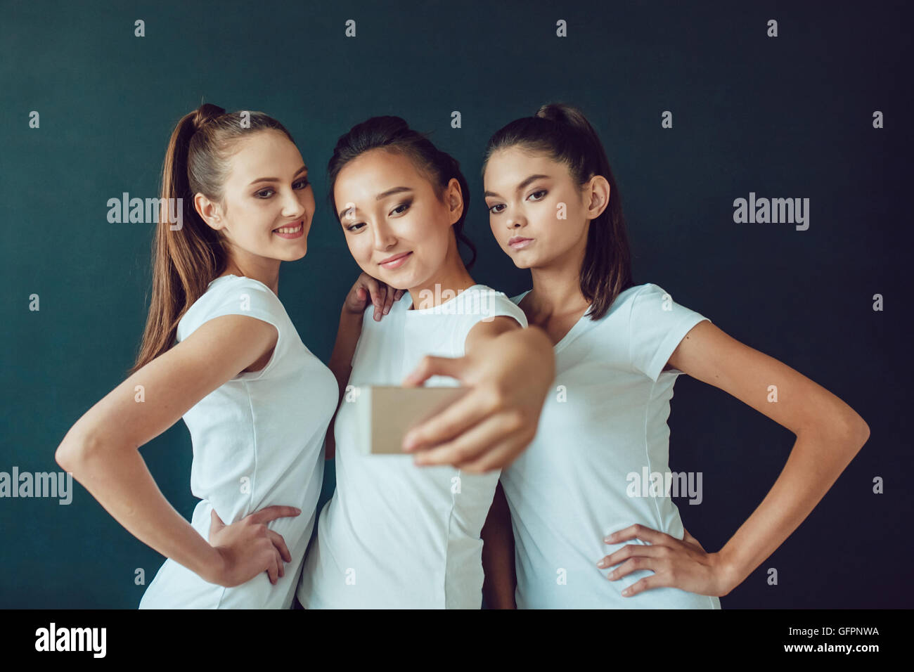 Positive friends portrait of happy girls making selfie, sure funny ...