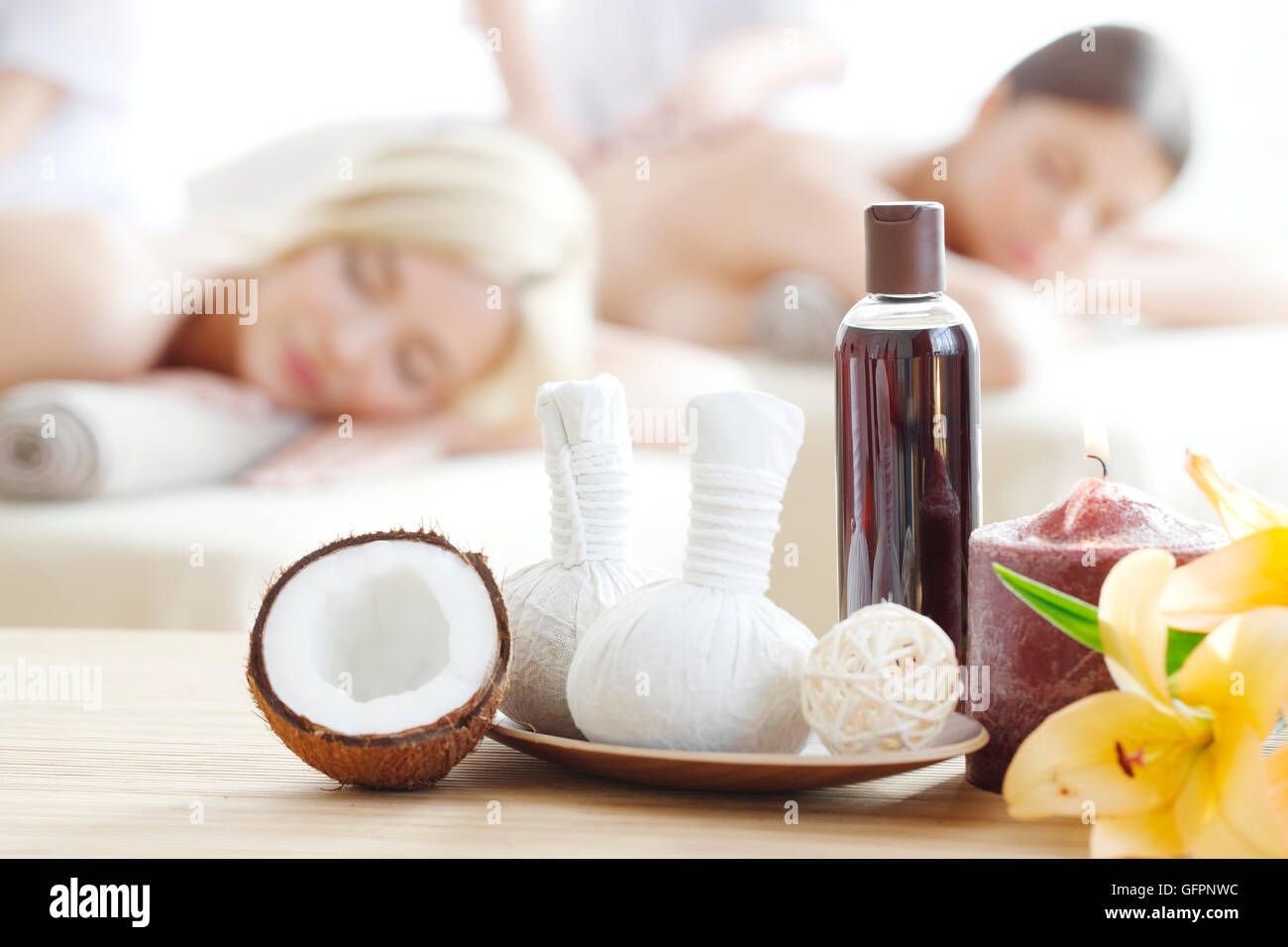 Spa massage tools and women getting massage on background Stock Photo ...