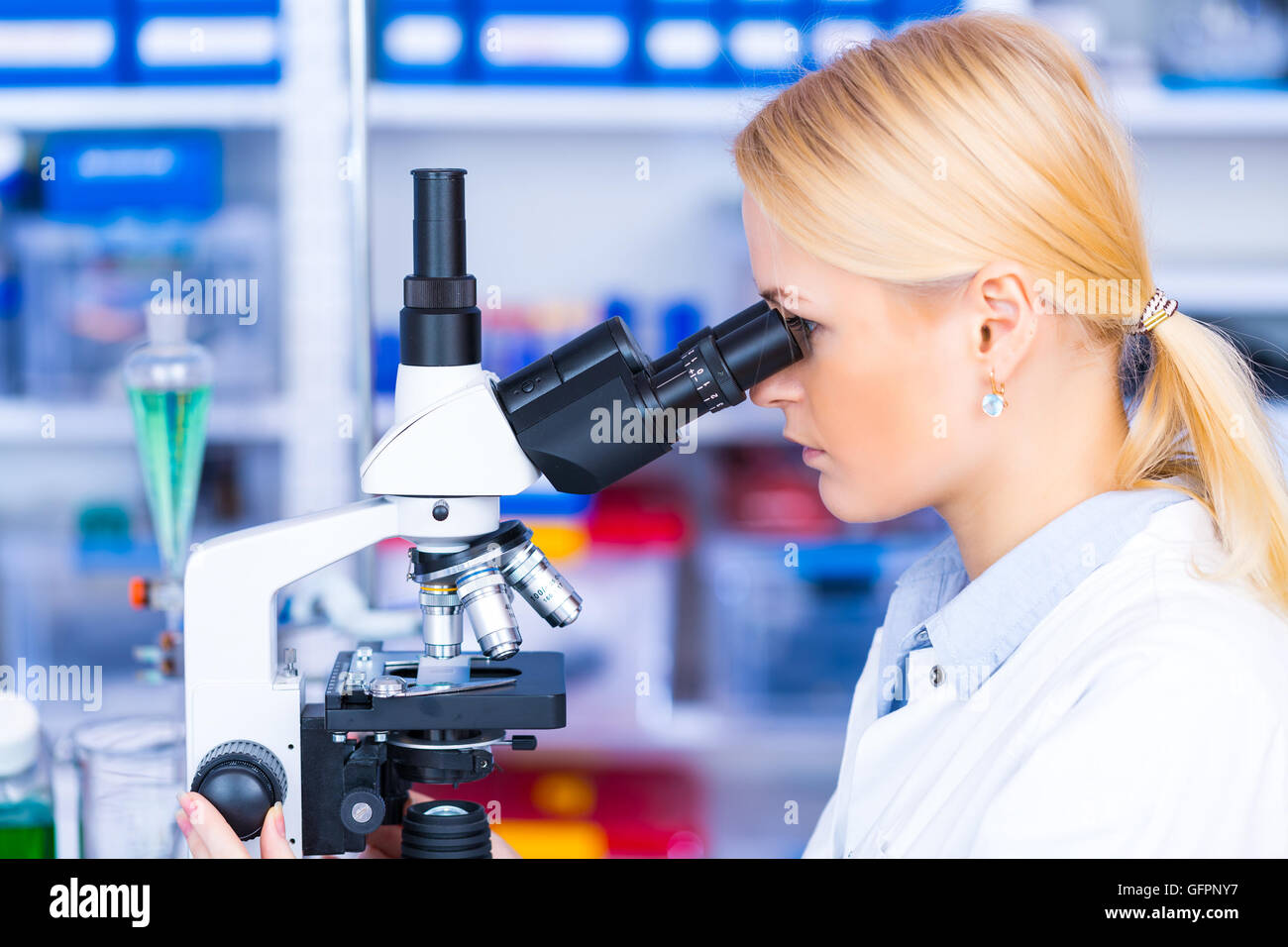 Scientist using a microscope in a laboratory Stock Photo - Alamy