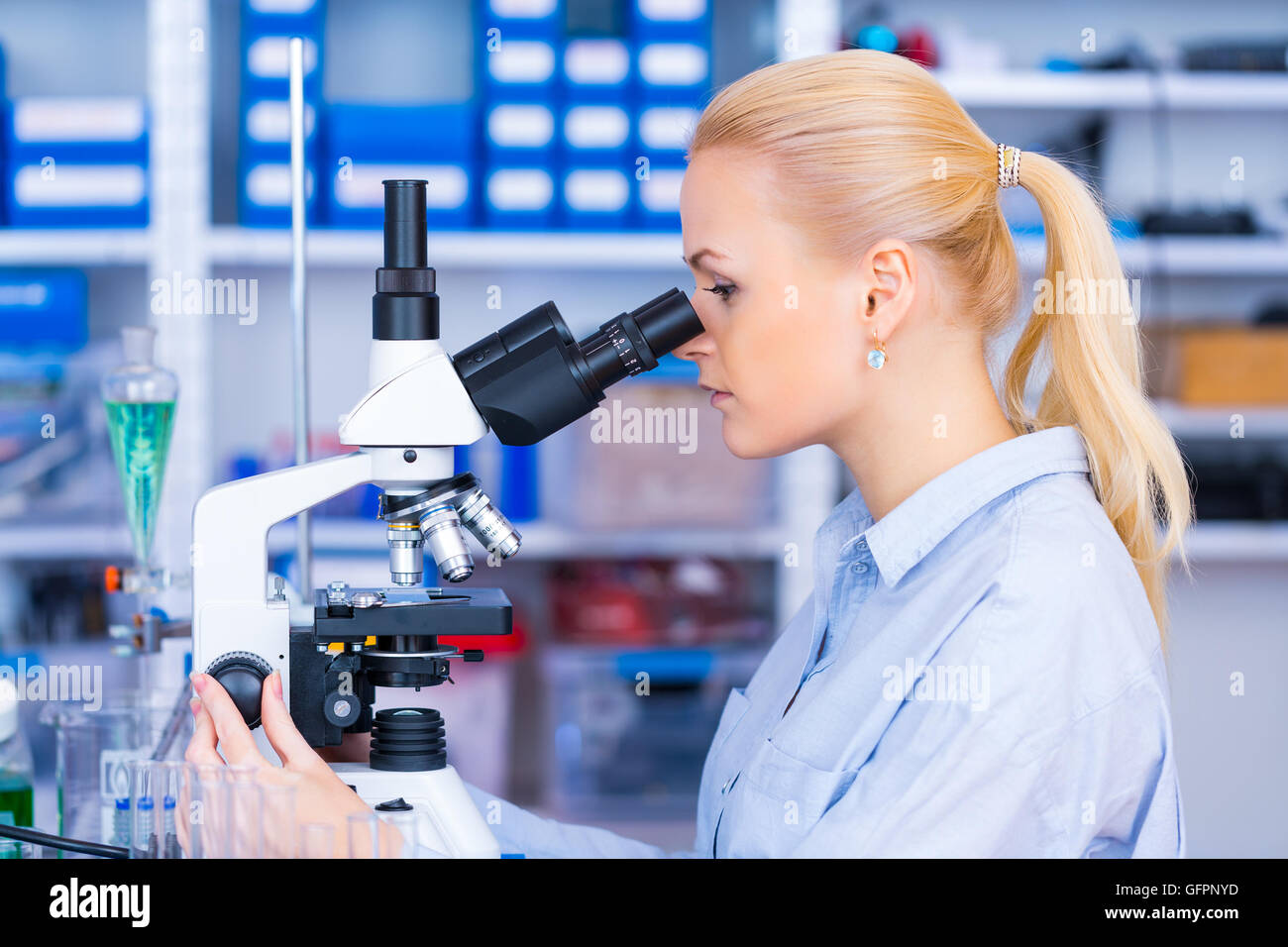 Scientist using a microscope in a laboratory Stock Photo - Alamy