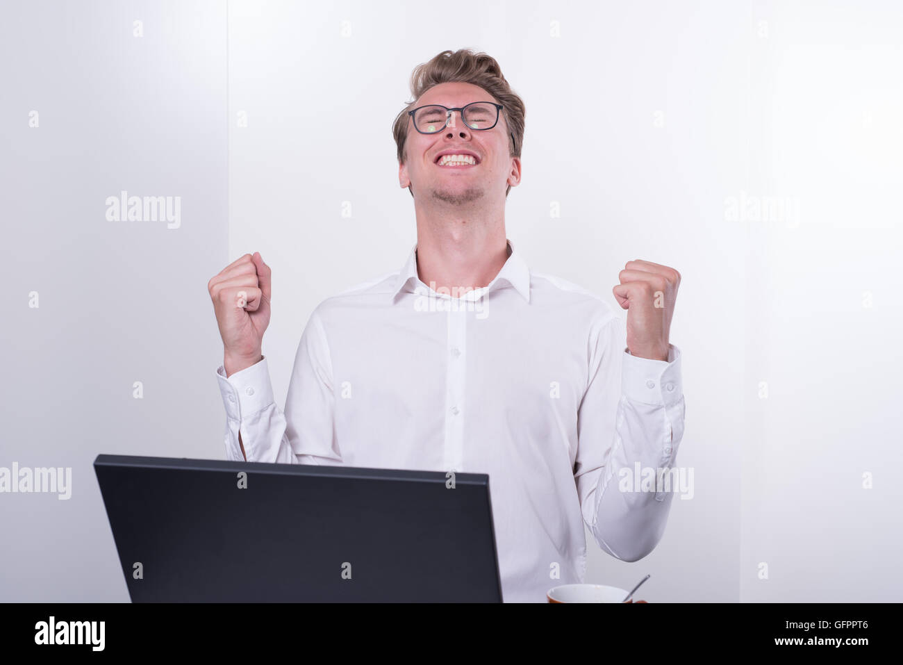 young business man cheering his success while working on laptop Stock ...