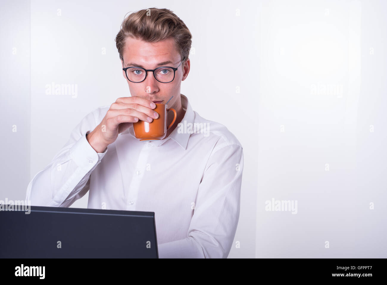 young business man having a coffee while working with laptop Stock ...