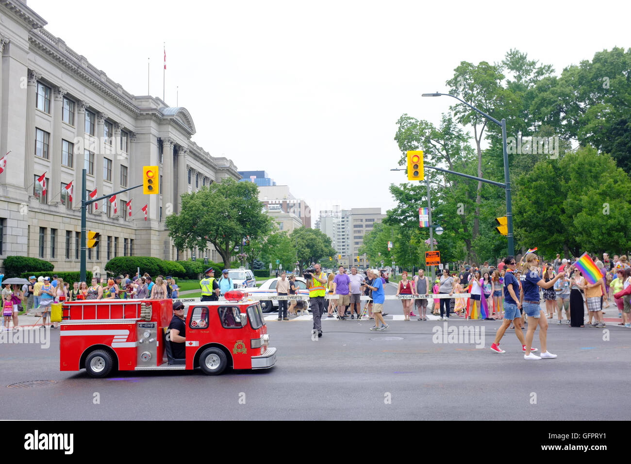 A small fire engine driving in a Pride parade in the Canadian city of ...