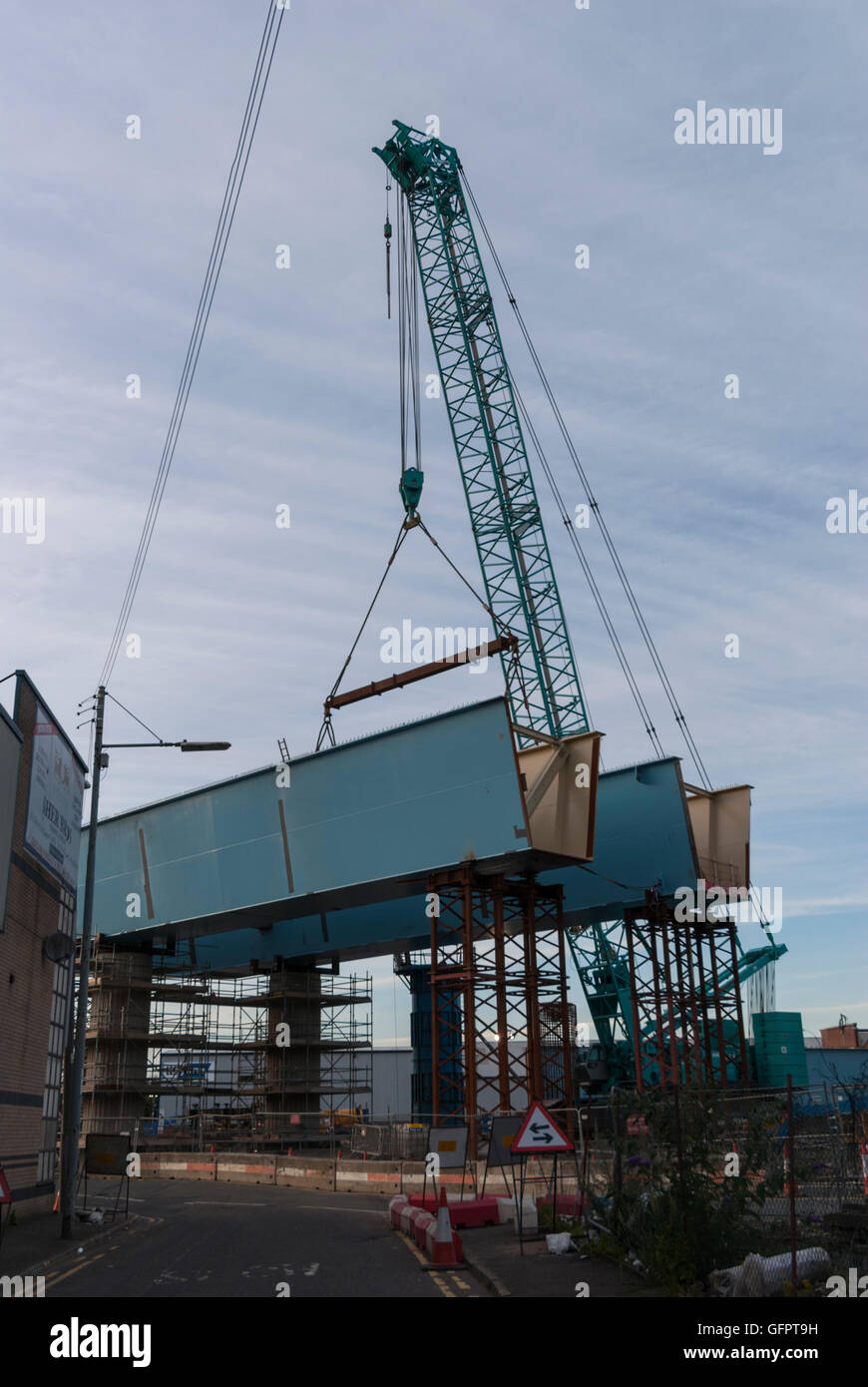 Box girder section suspended by crane, M74 extension bridge ...