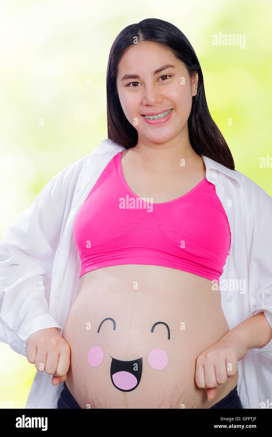 Happy pregnant woman with smiley face on her belly Stock Photo - Alamy
