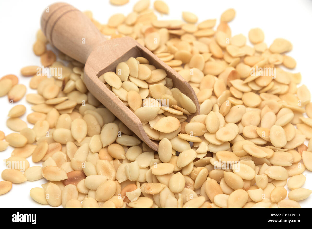 Shelled melon seeds with salt on white background Stock Photo - Alamy