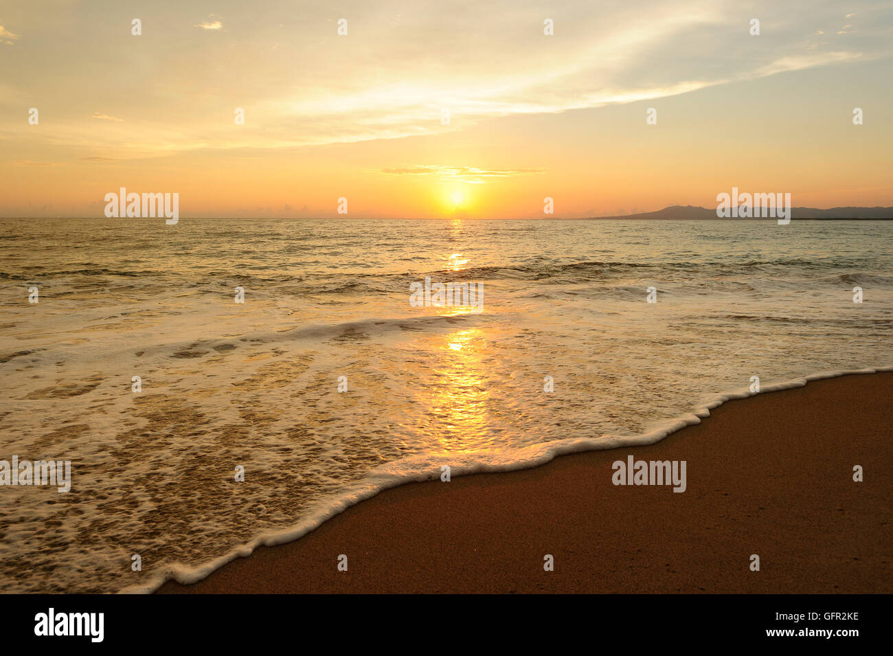 Ocean sunset is a brightly beach with the sun setting on the ocean ...