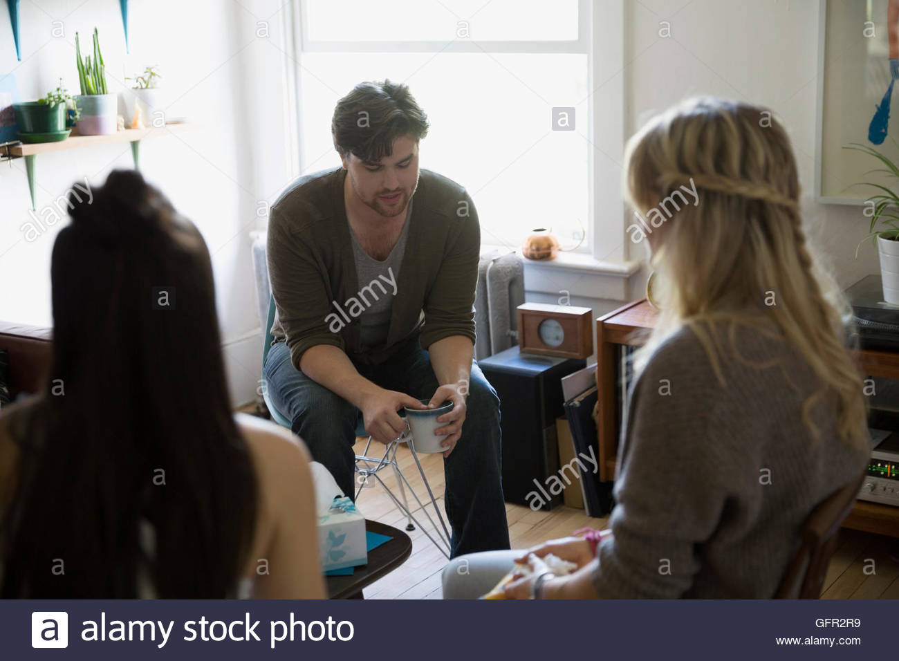Support group talking meeting in living room Stock Photo - Alamy
