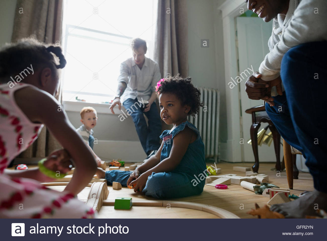 Fathers and children enjoying play date in living room Stock Photo - Alamy