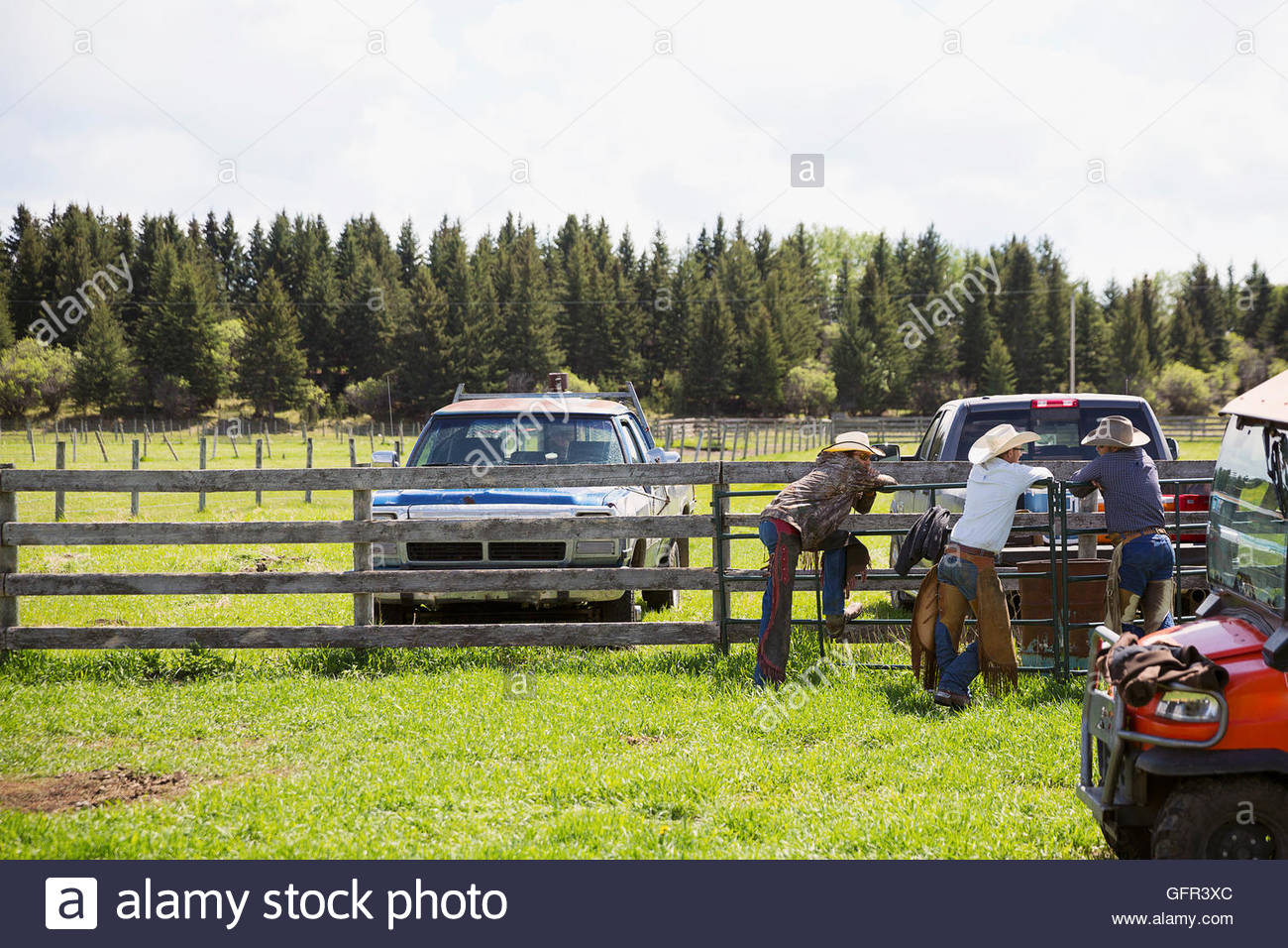 Cattle ranchers talking at fence on ranch Stock Photo - Alamy