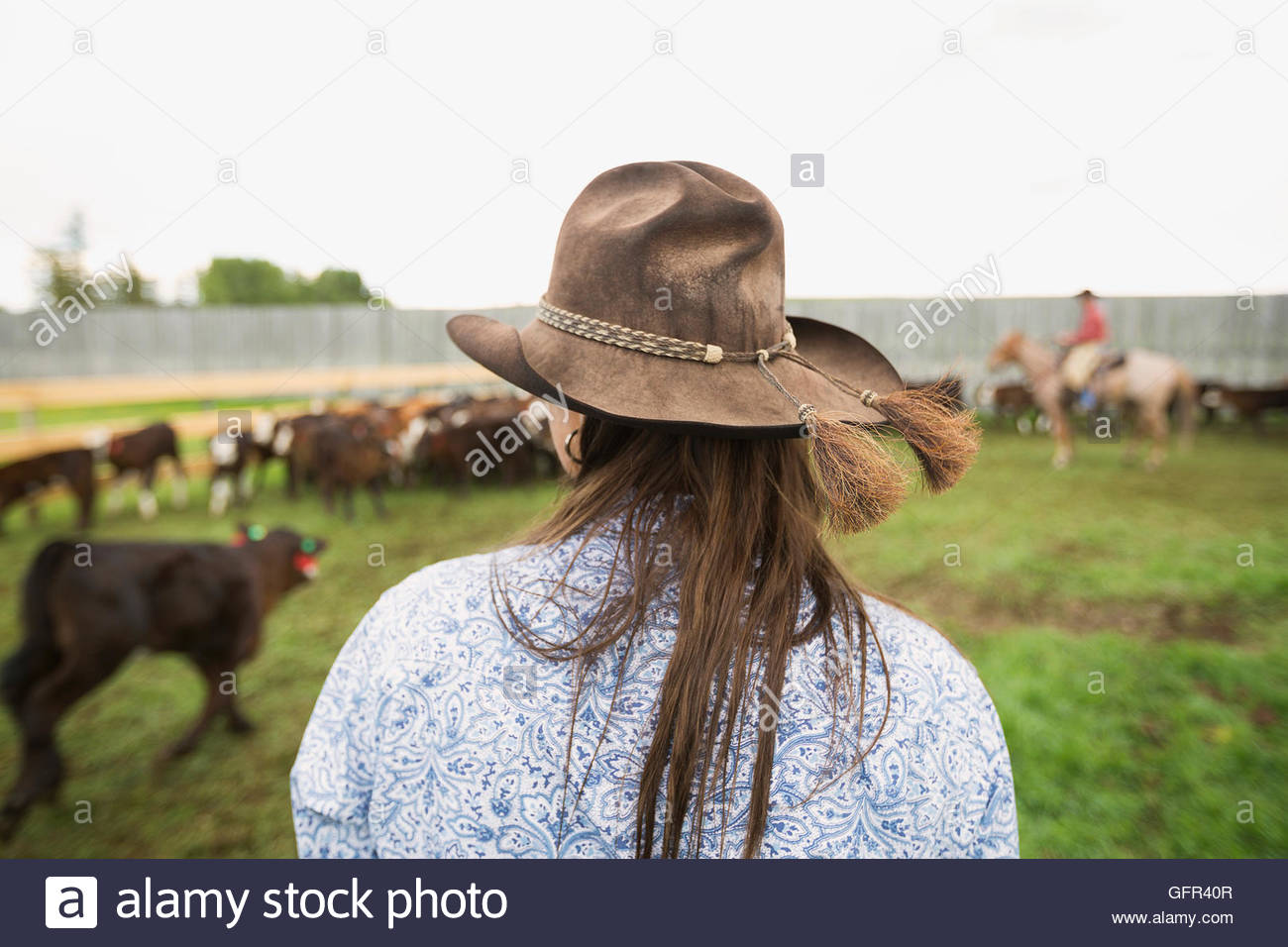 Female cattle rancher wearing cowboy hat Stock Photo - Alamy