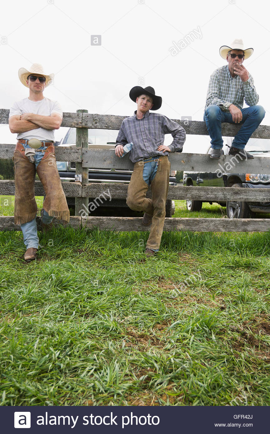 Portrait confident cattle ranchers at fence Stock Photo - Alamy