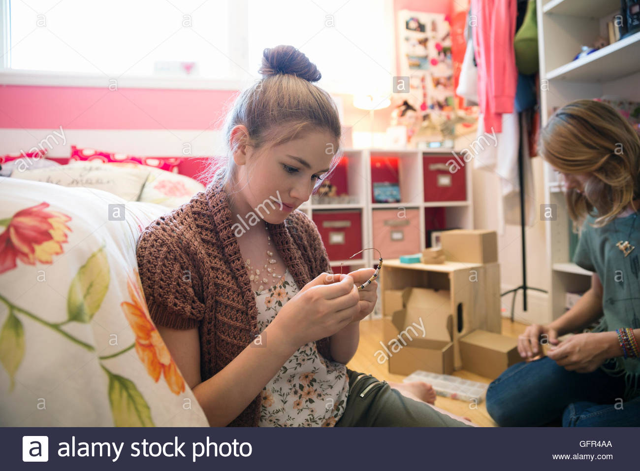 Girls making jewelry in bedroom Stock Photo - Alamy