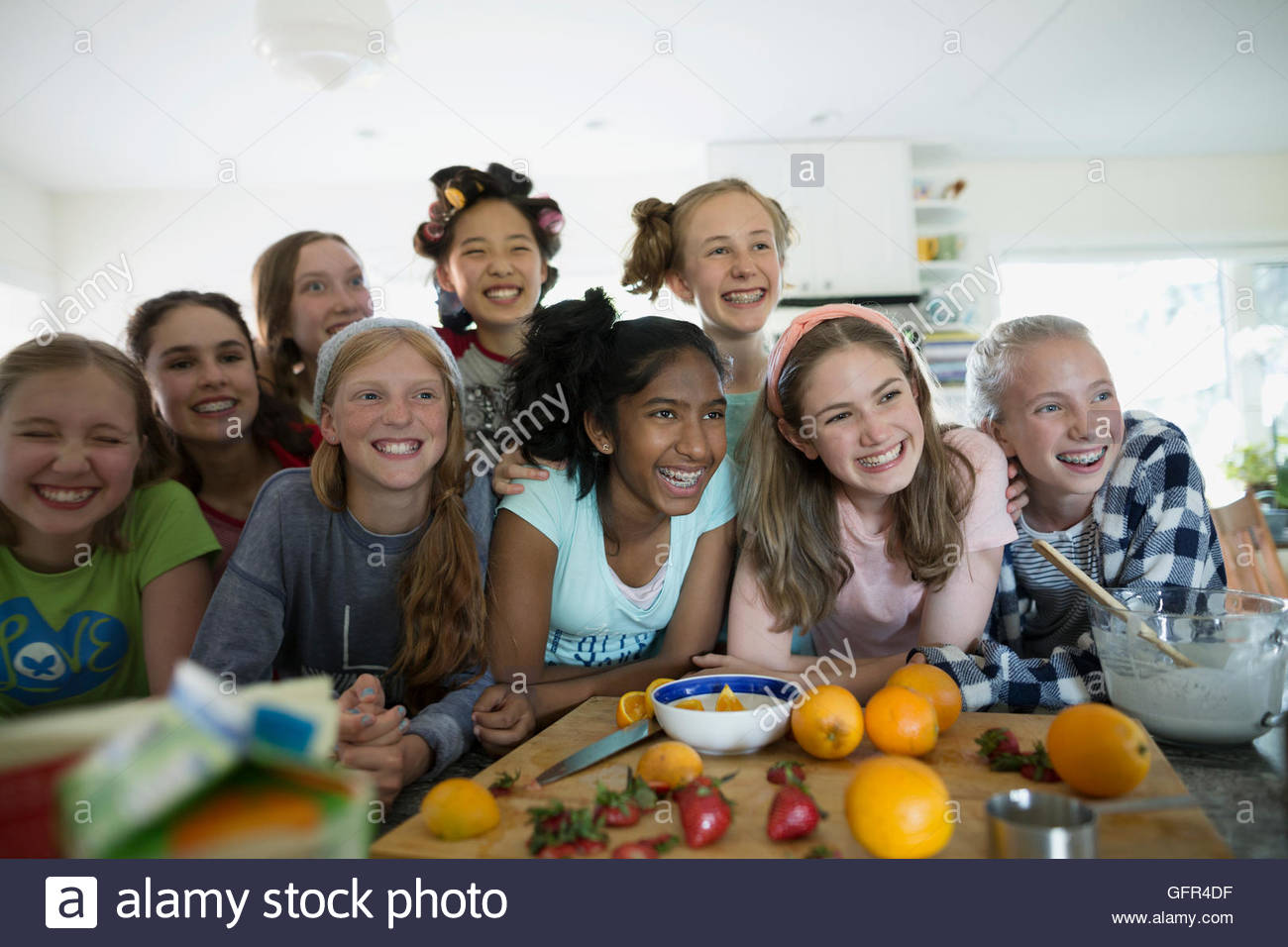 Portrait smiling girls enjoying slumber party cooking in kitchen Stock ...