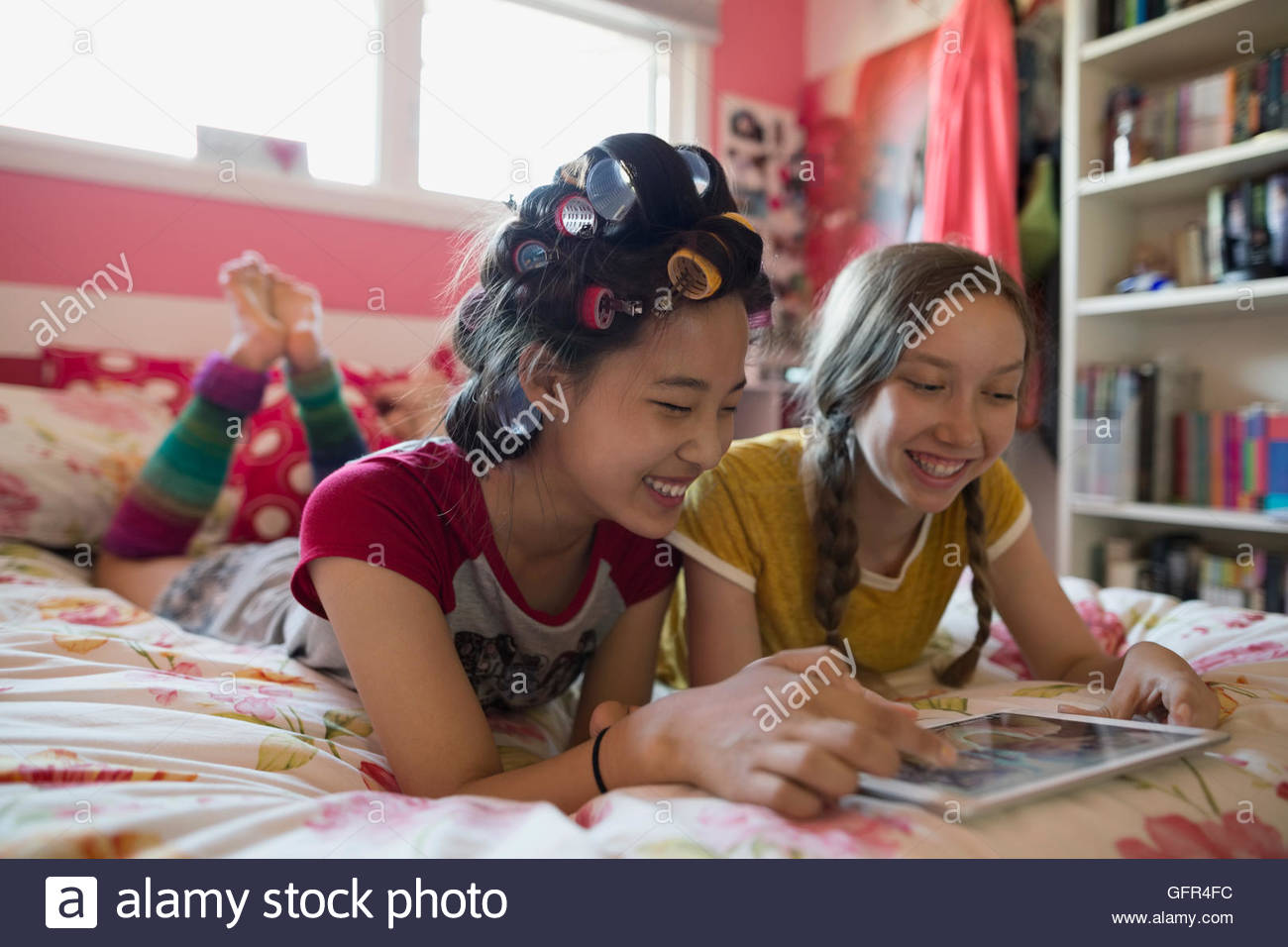 Girls using digital tablet on bed Stock Photo - Alamy