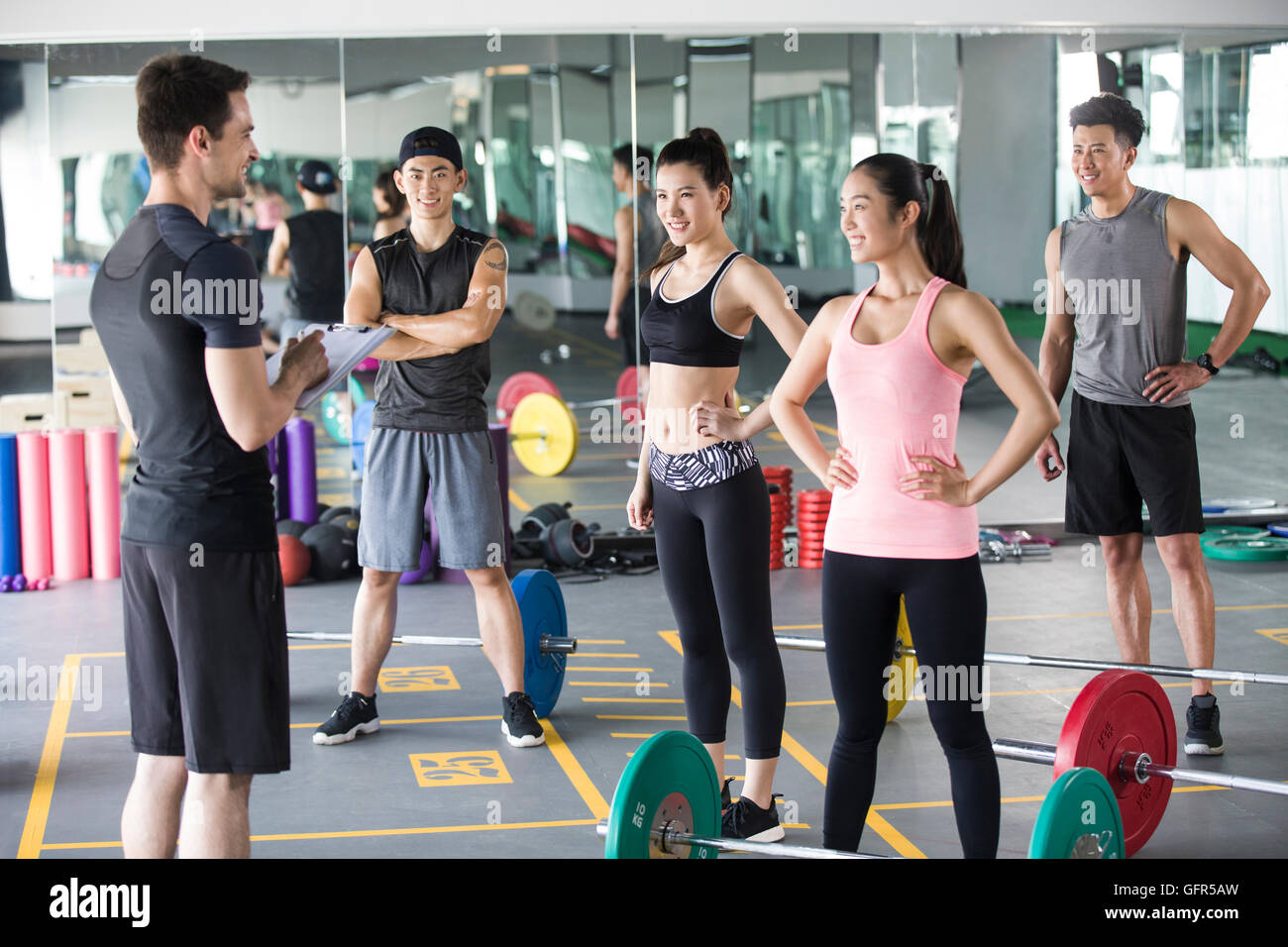 Young Chinese adult working with trainer at gym Stock Photo - Alamy