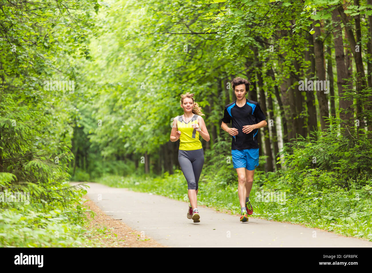 Running together - friends jogging in park Stock Photo - Alamy