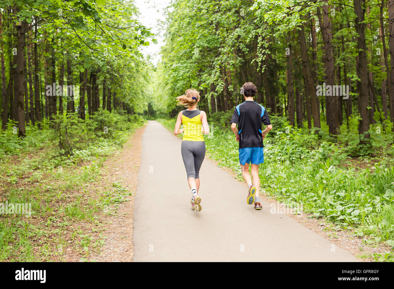 Two friends jog side hi-res stock photography and images - Alamy