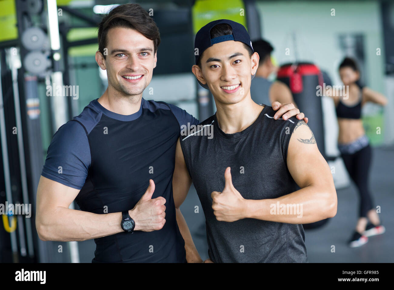 Portrait of young Chinese man and his personal coach Stock Photo - Alamy