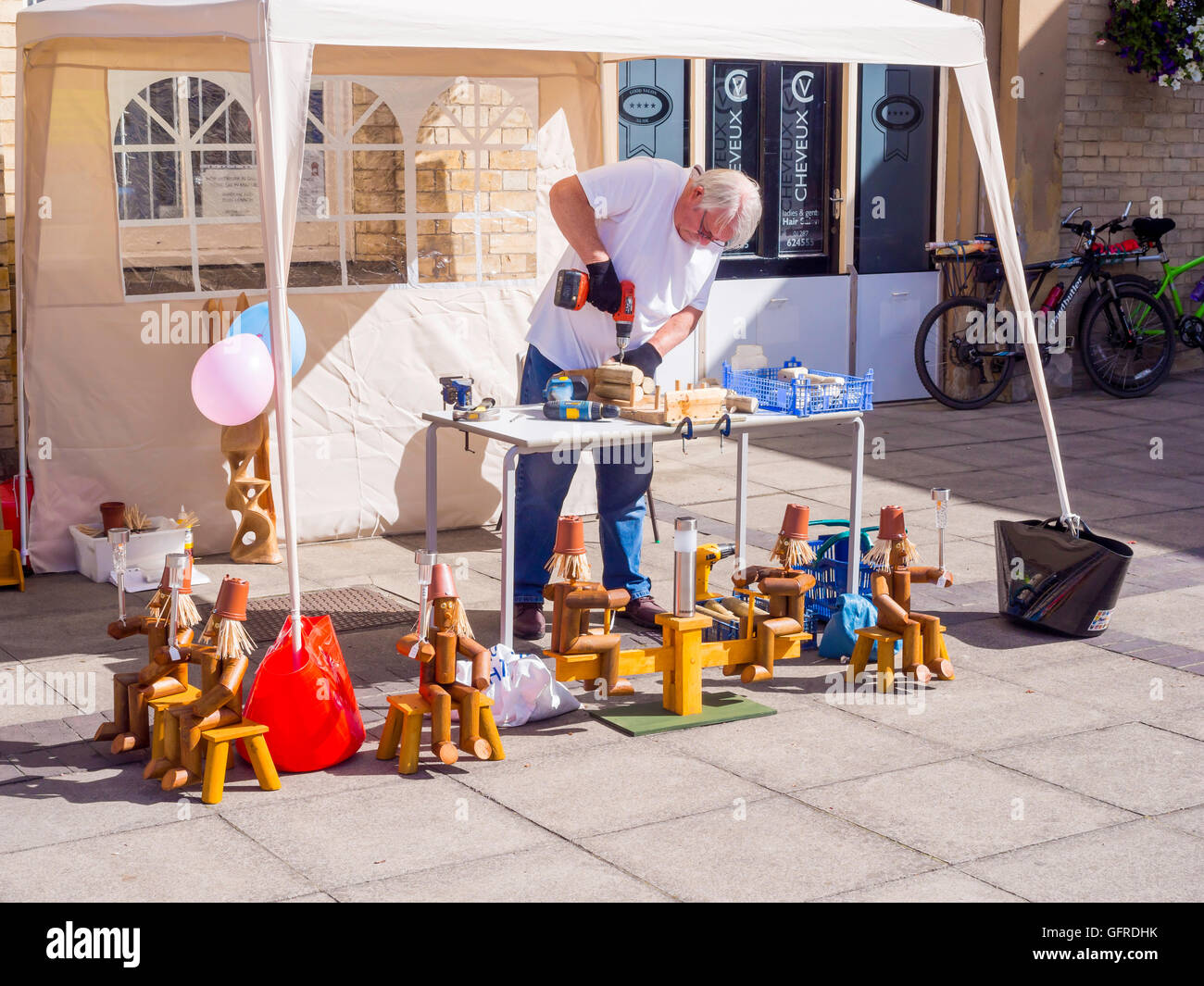 Craft Fair a man making and selling wooden garden ornaments like ...