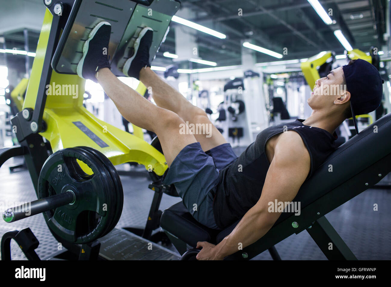 Young Chinese man exercising at gym Stock Photo - Alamy