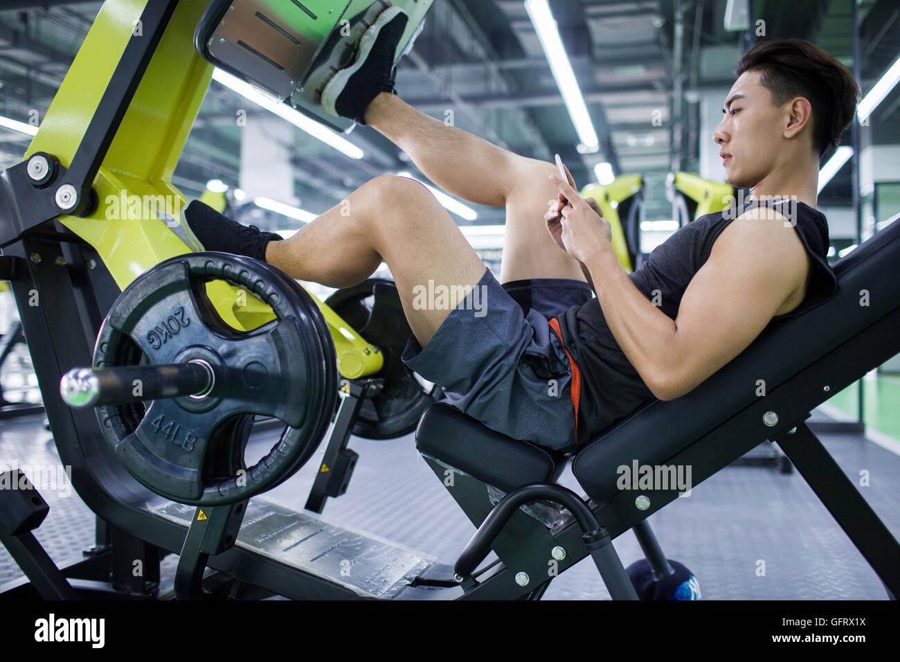 Young Chinese man exercising at gym Stock Photo - Alamy