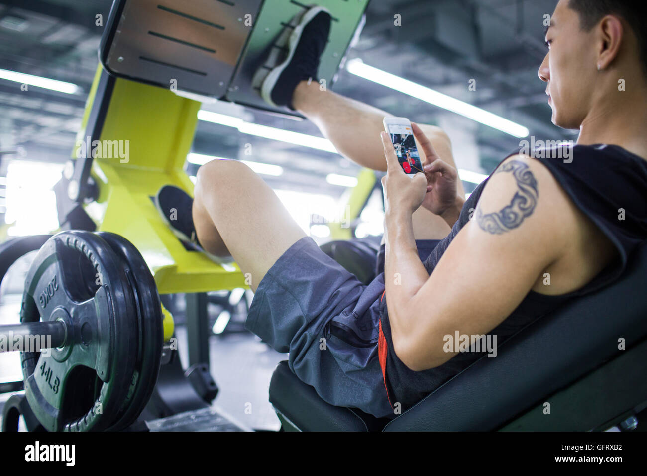 Young Chinese man exercising at gym Stock Photo - Alamy