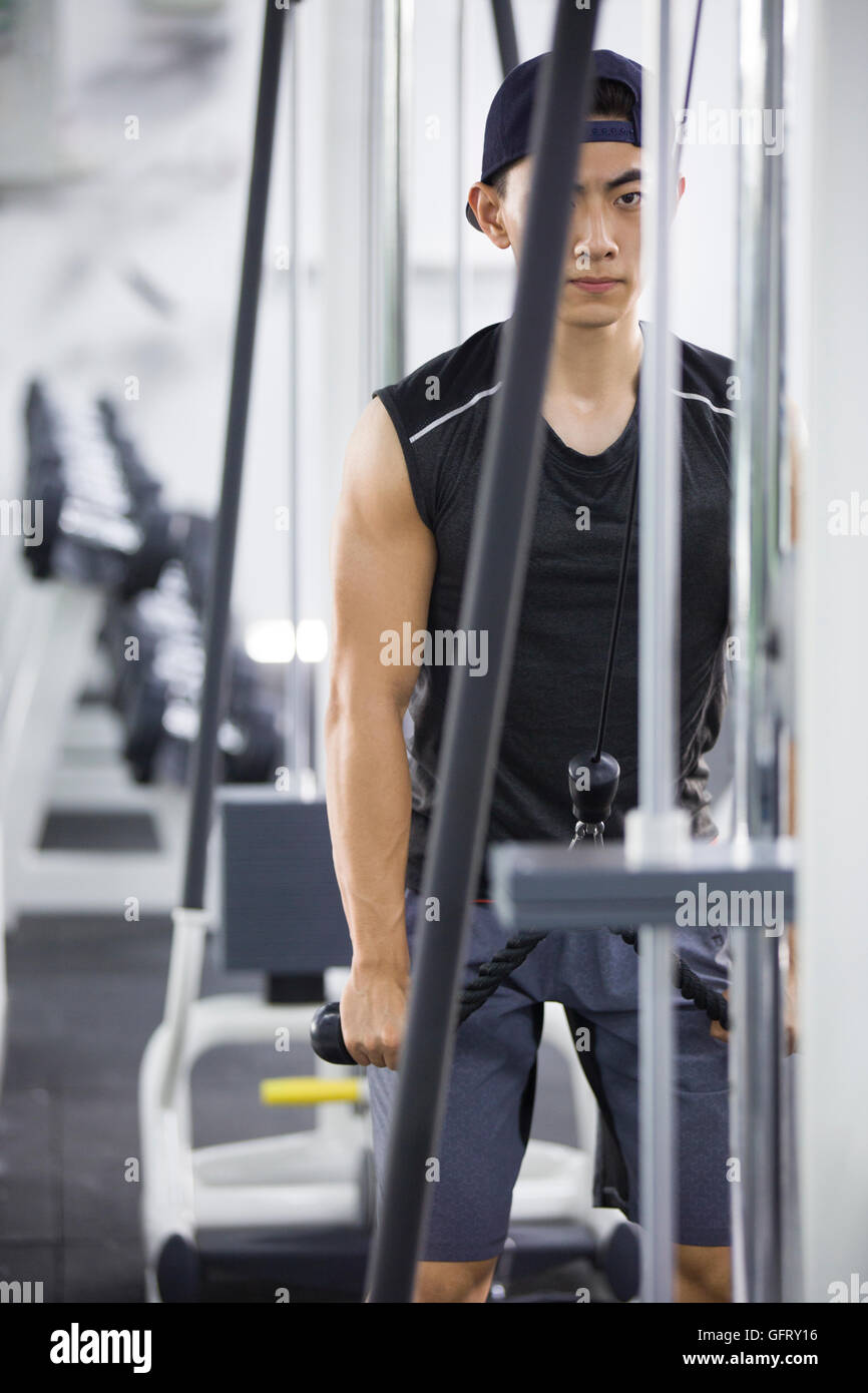 Young Chinese man exercising at gym Stock Photo - Alamy