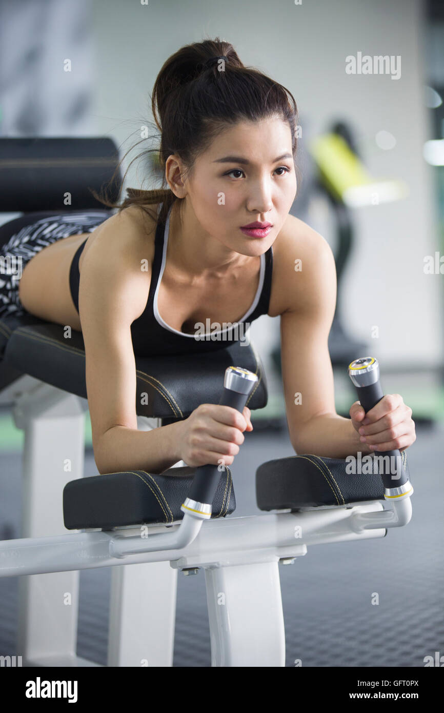 Young Chinese woman exercising at gym Stock Photo - Alamy