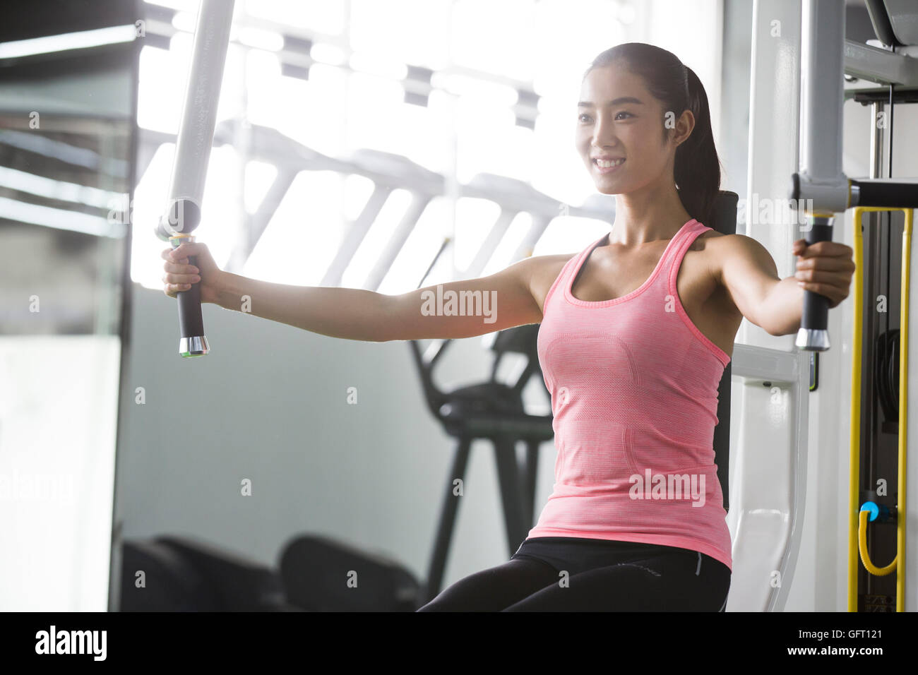 Young Chinese woman exercising at gym Stock Photo - Alamy