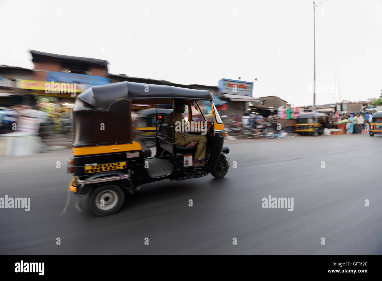 Brand new shiny auto rickshaw riding over the streets of Mumbai ...