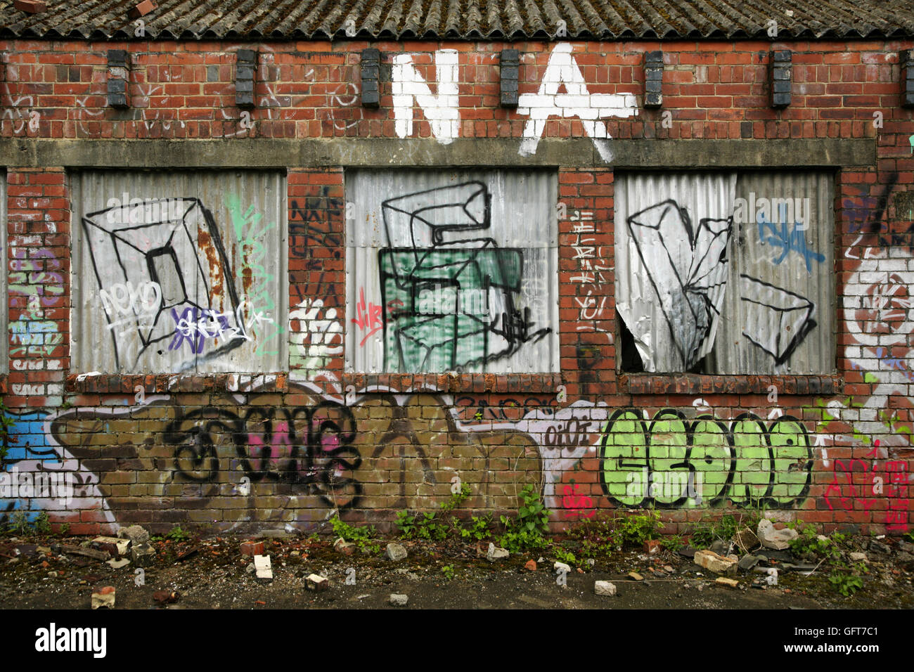 Graffiti and vandalism on abandoned derelict industrial building Stock ...