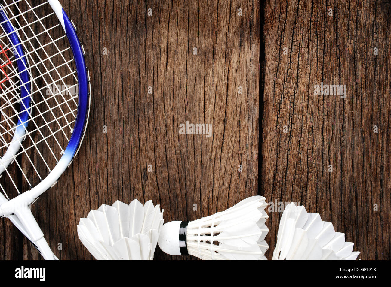 wooden background with badminton racket and shuttlecocks Stock Photo ...