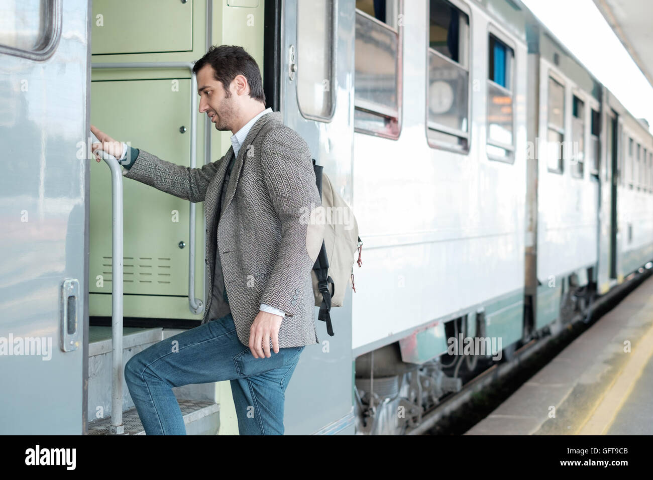 standing man leaving on the train in a train station platform Stock ...