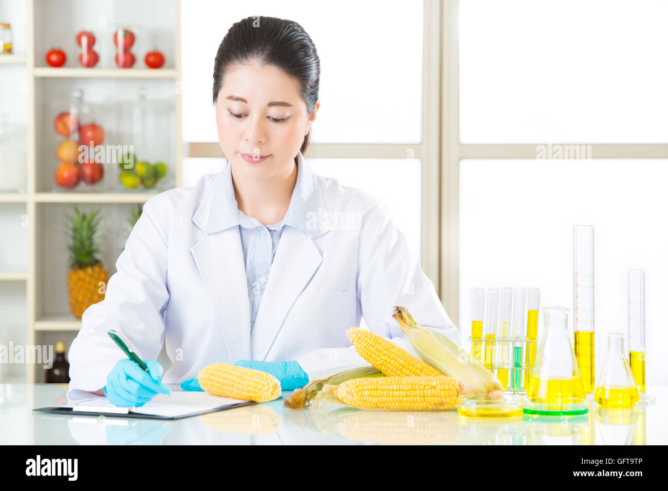 Asian female scientist Recording her data is important for genetic ...