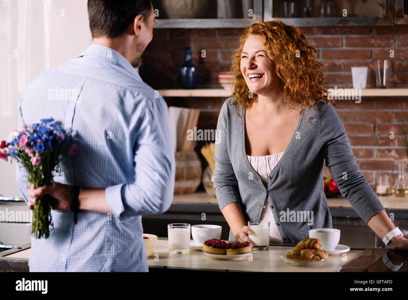Man holding bunch of flowers behind back Stock Photo - Alamy