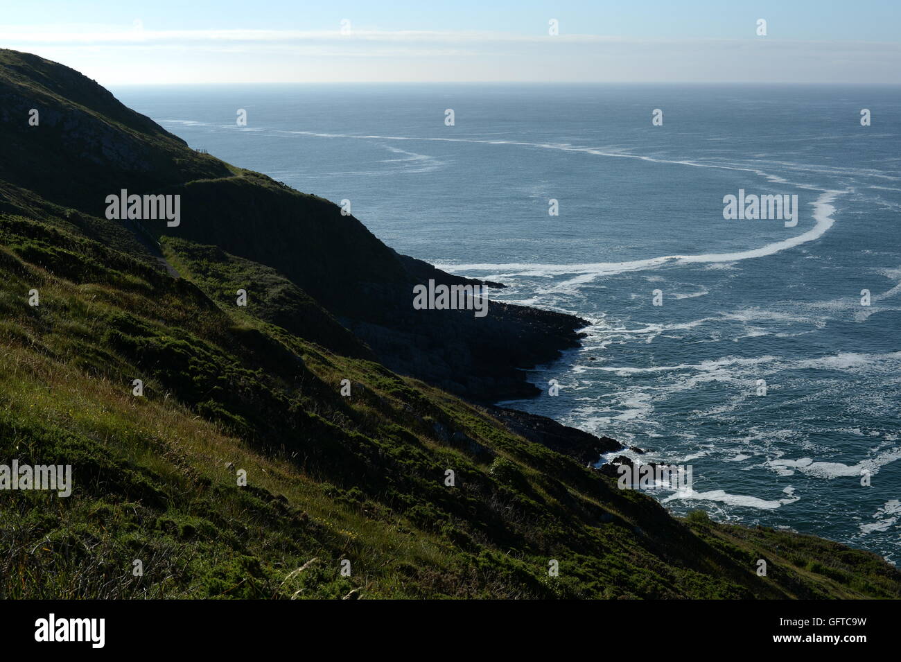surf lined headland and cliffs from coast path to Langland from Mumbles ...