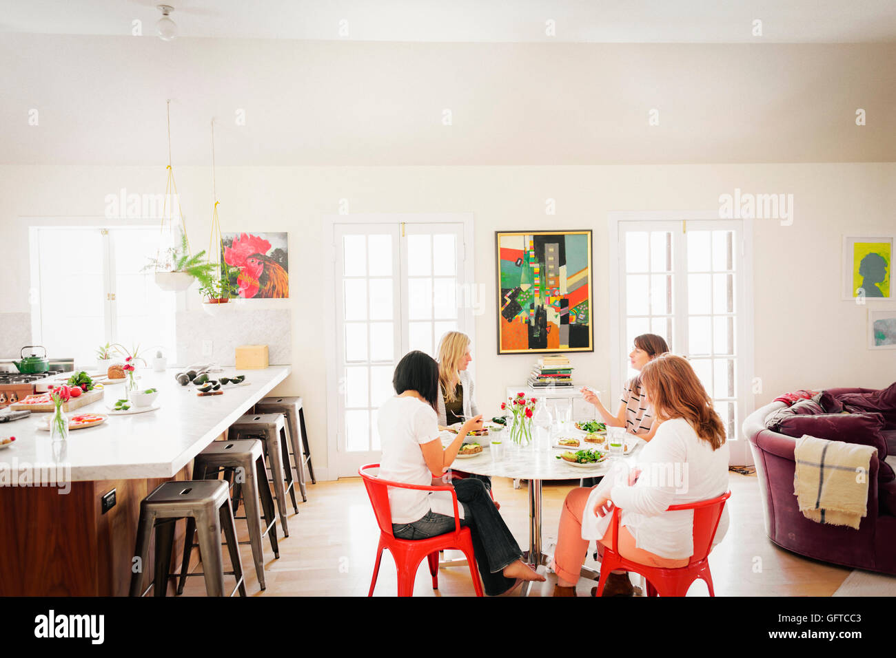 Four women friends having lunch Stock Photo - Alamy