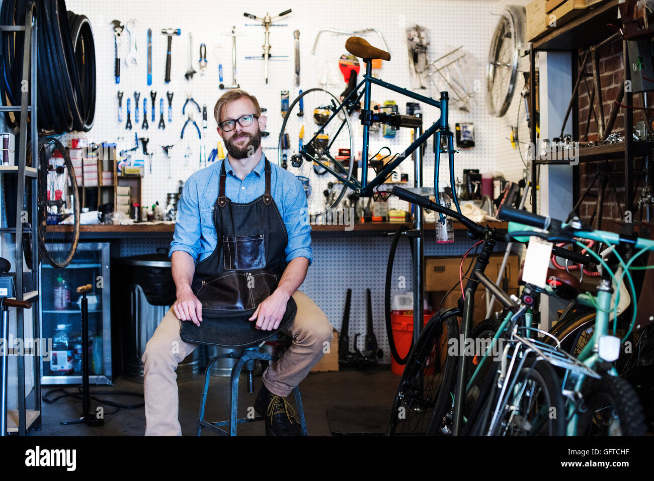 A man working in a bicycle repair shop Stock Photo - Alamy
