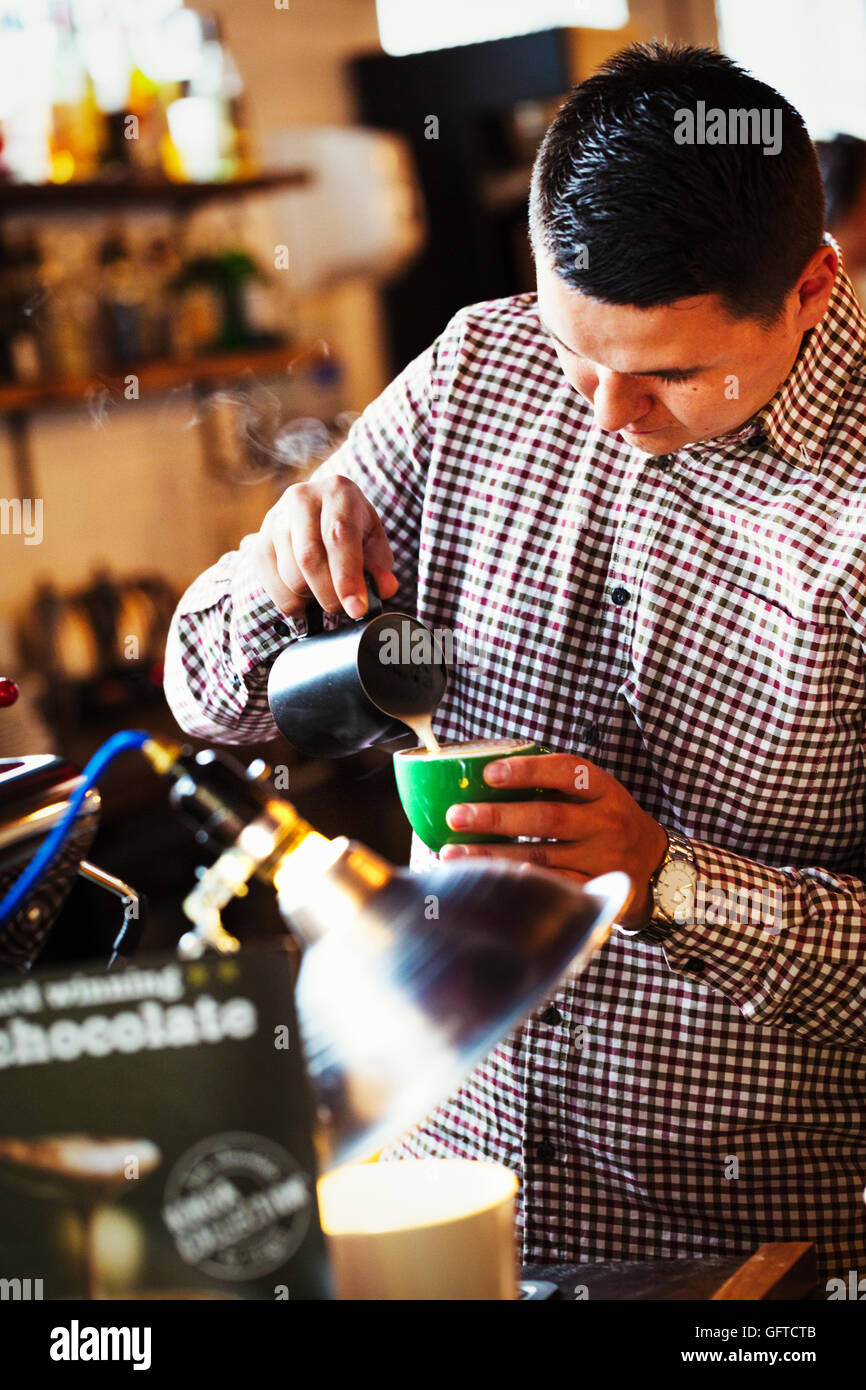 Young owner making coffee hi-res stock photography and images - Alamy