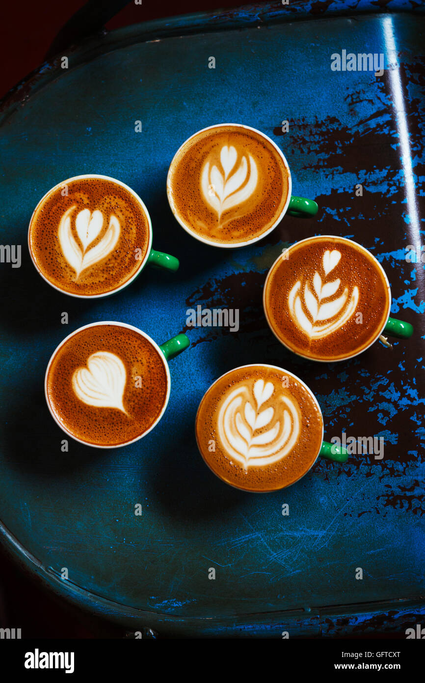 Cups of coffee with patterns in the froth on the top Stock Photo - Alamy