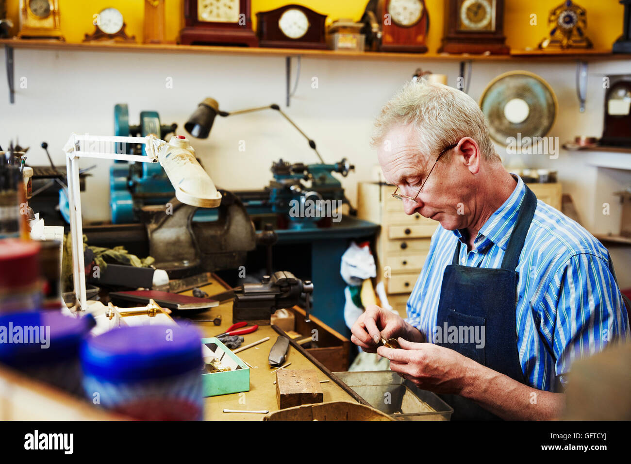 A clock maker busy in his workshop Stock Photo - Alamy
