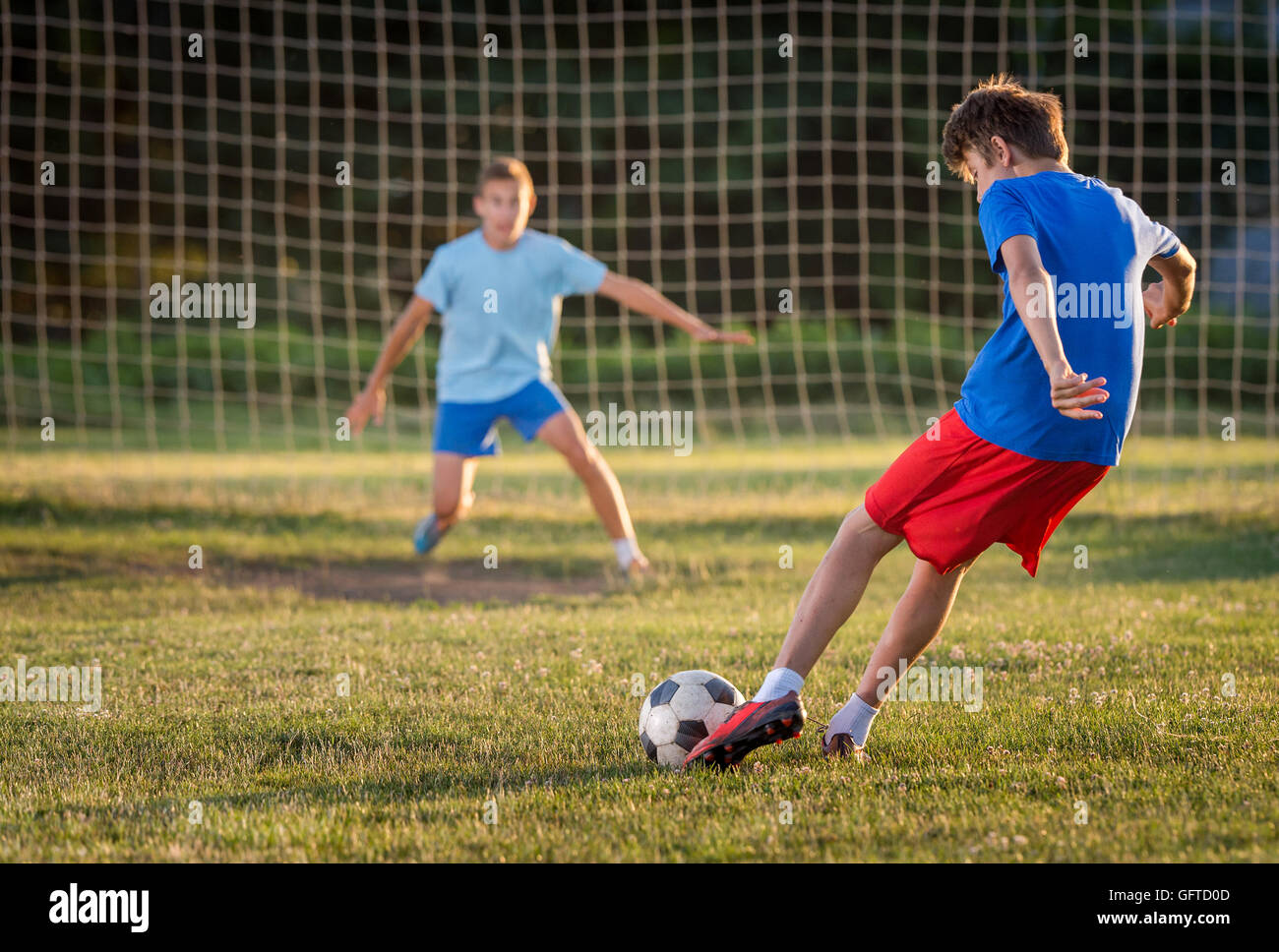 Boy age 8 playing football hi-res stock photography and images - Alamy