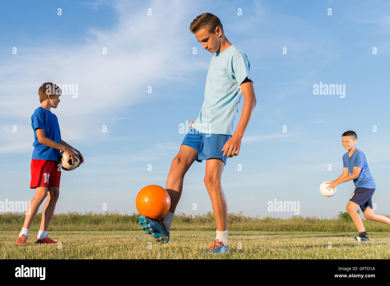 Boy on the football training on the court Stock Photo - Alamy