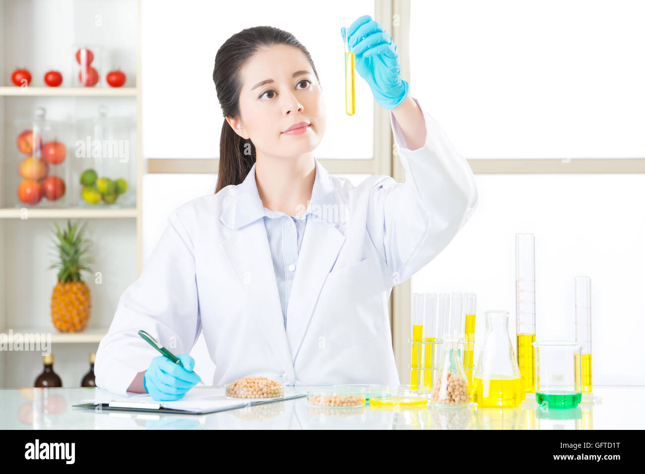 scientist recording on clipboard of gmo food research Stock Photo - Alamy