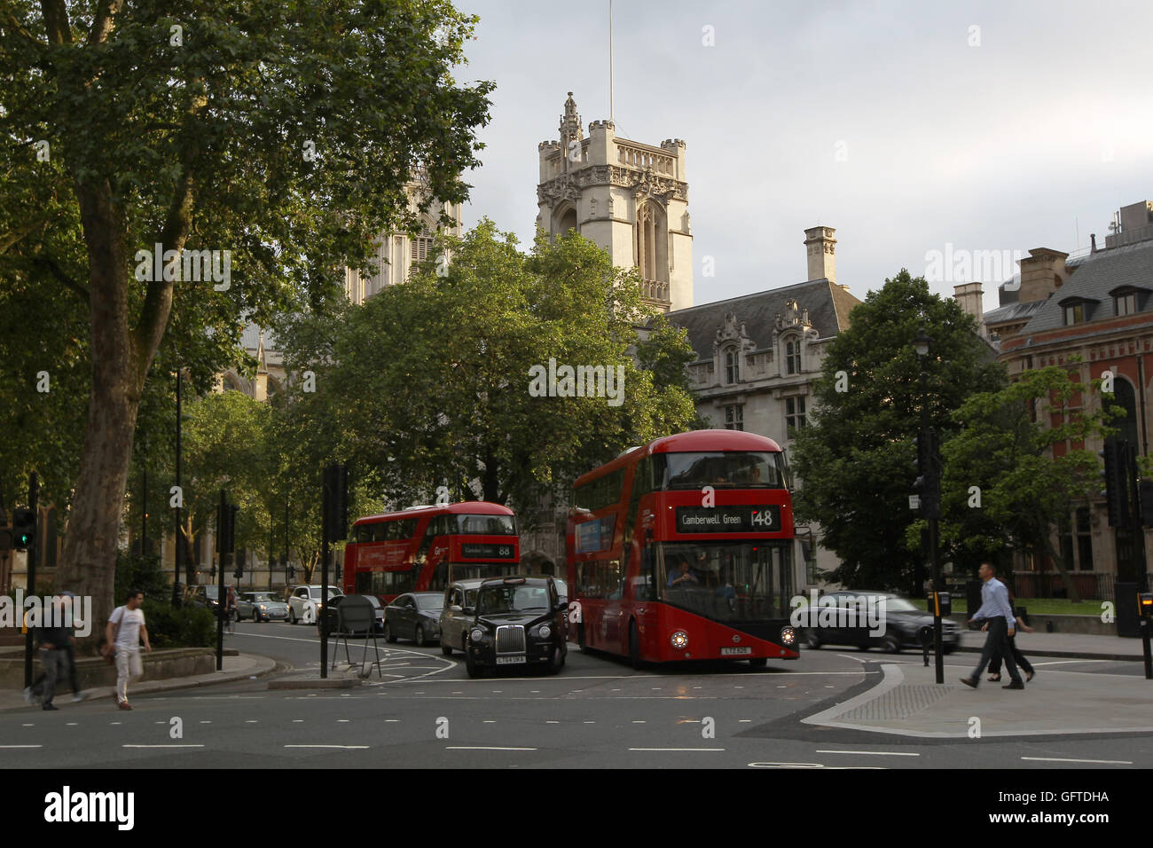 London transport buses and taxi heading into Parliament square Stock ...