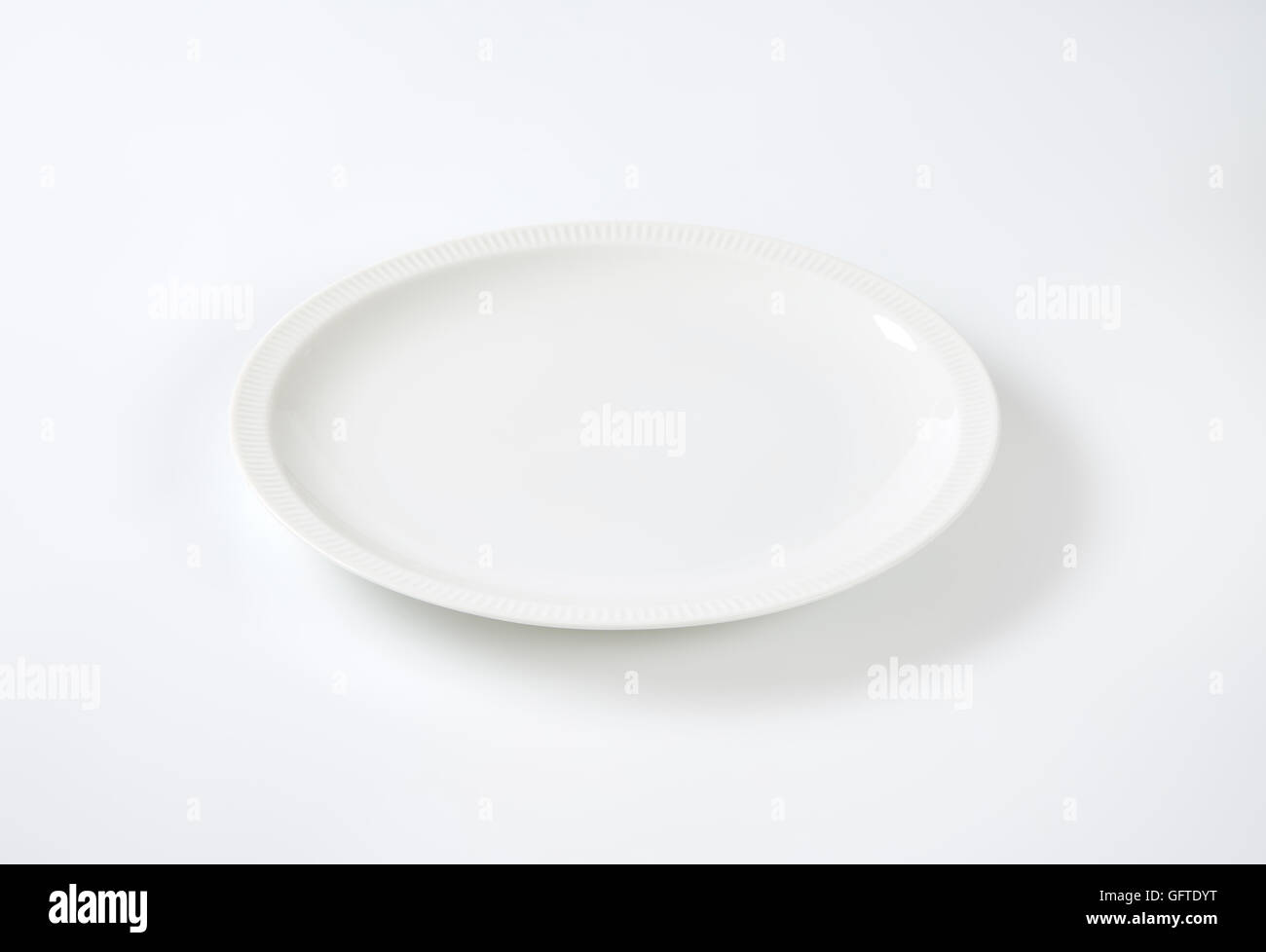 Round porcelain plate with ribbed edge Stock Photo - Alamy