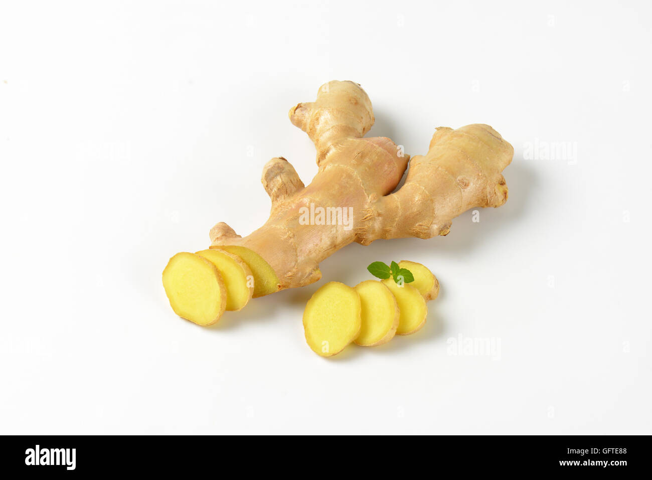 sliced fresh ginger on white background Stock Photo - Alamy